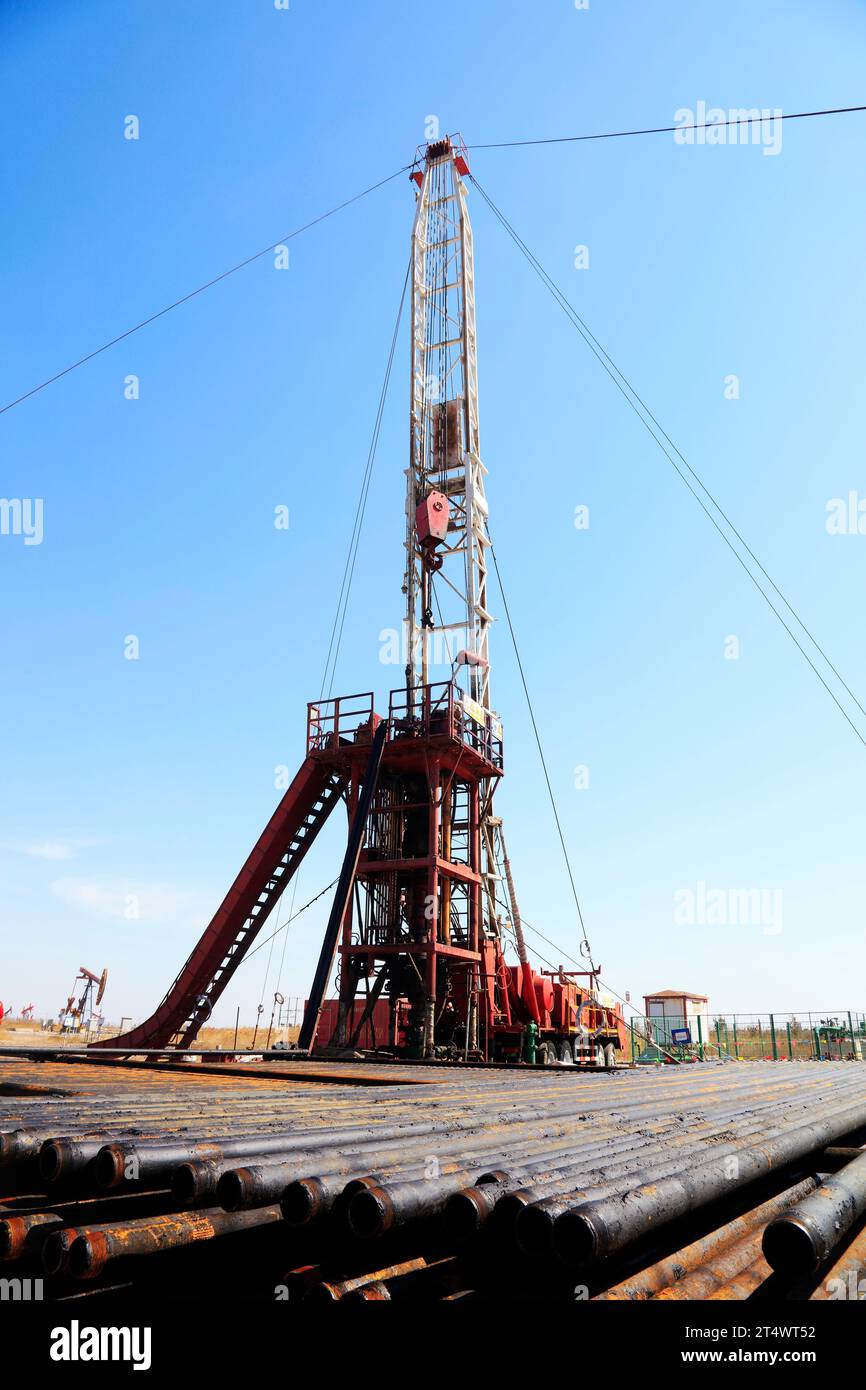Oil drilling derrick and metal pipe Stock Photo - Alamy