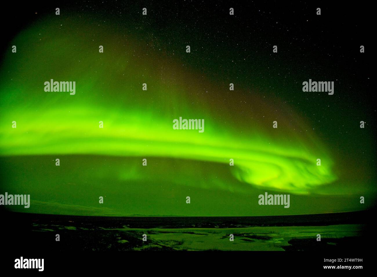 Northern lights Aurora borealis glow brightly and snake across the ...