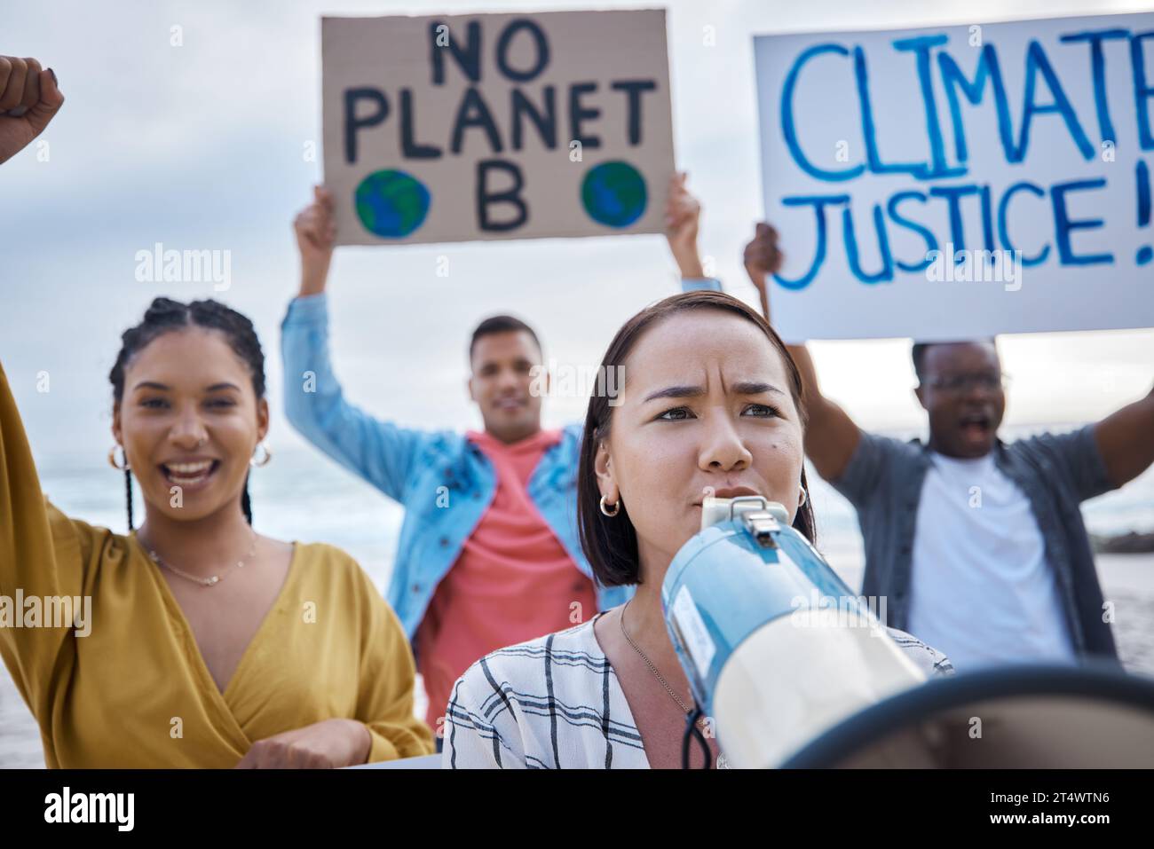 Megaphone, climate change protest and Asian woman with crowd at beach ...