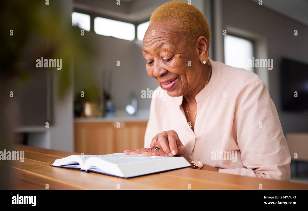 Home, spiritual and old woman reading a bible, faith and peace with ...