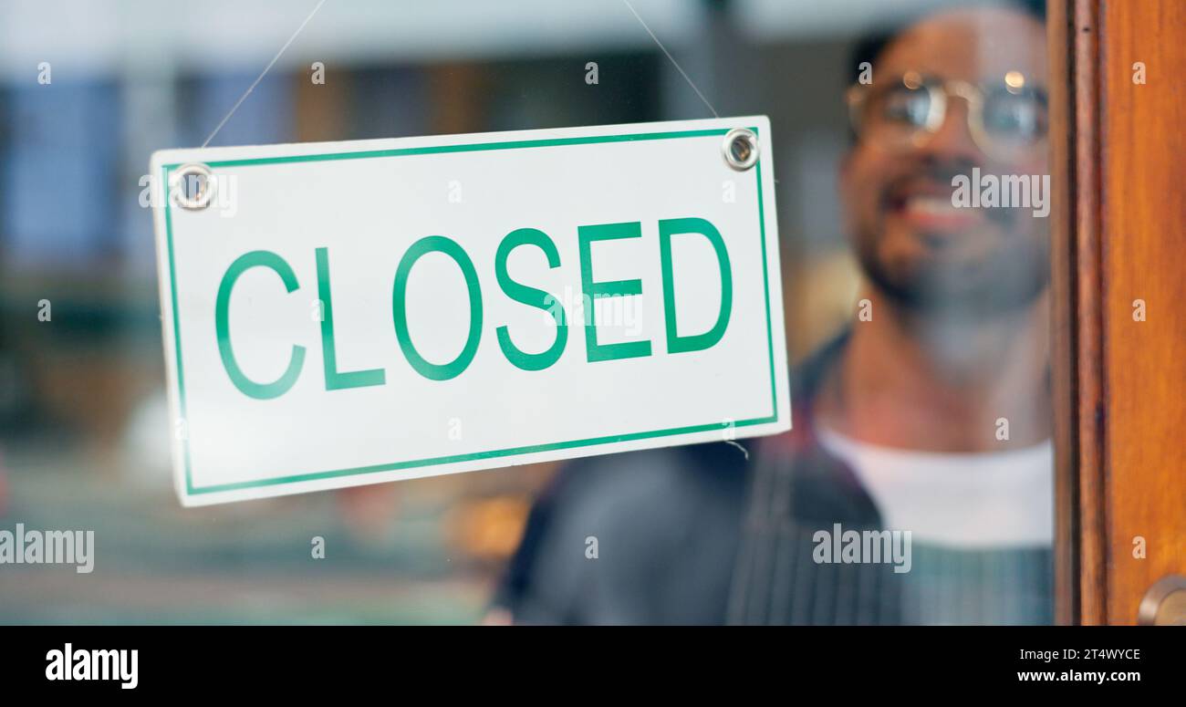 Happy man, small business or closed sign on window in coffee shop or ...
