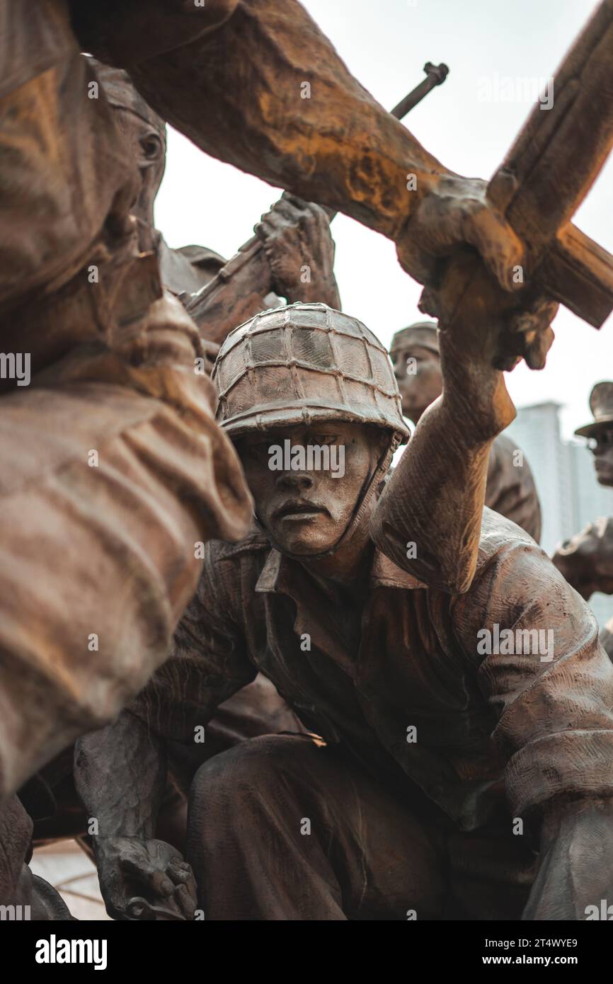 A collection of bronze statues of military personnel standing on a ...