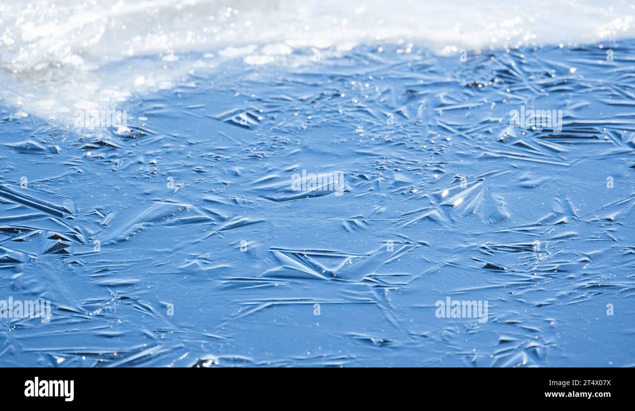 Thin ice covered with snow, frozen lake surface, natural background ...