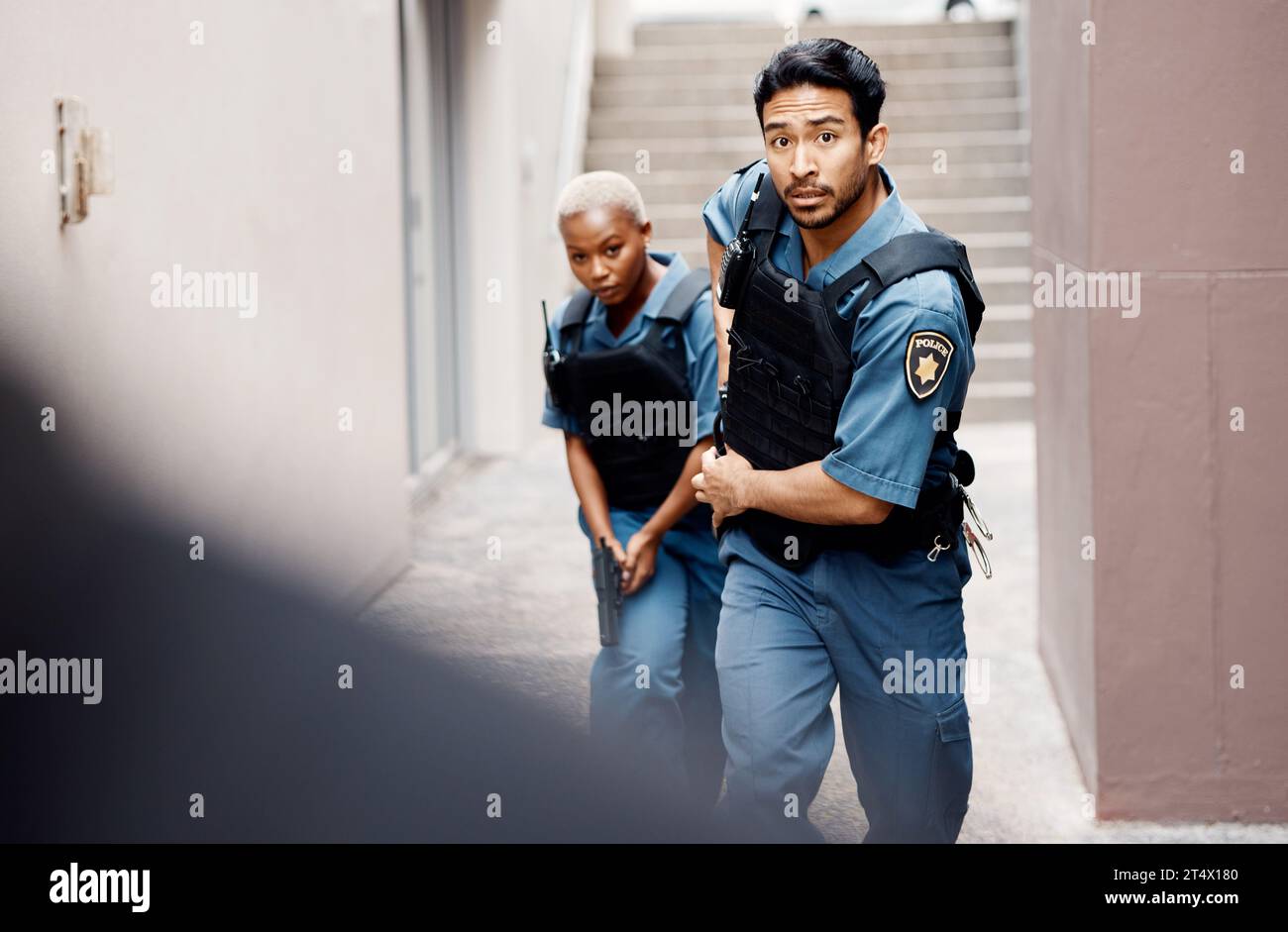 Asian man, police and gun running in city for suspect, investigation or ...