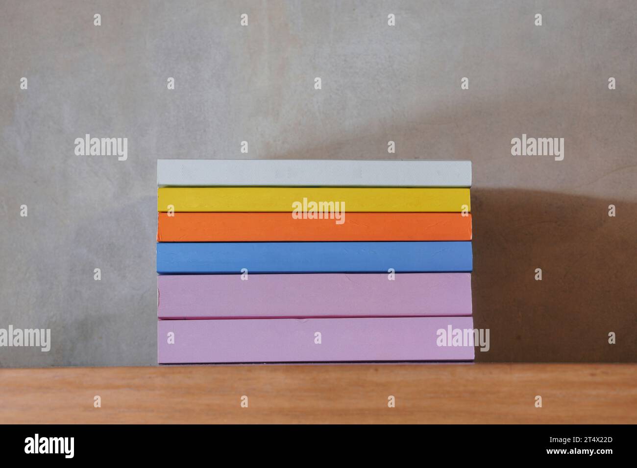 Stack of colorful books on floating wooden bookshelf. Education and ...
