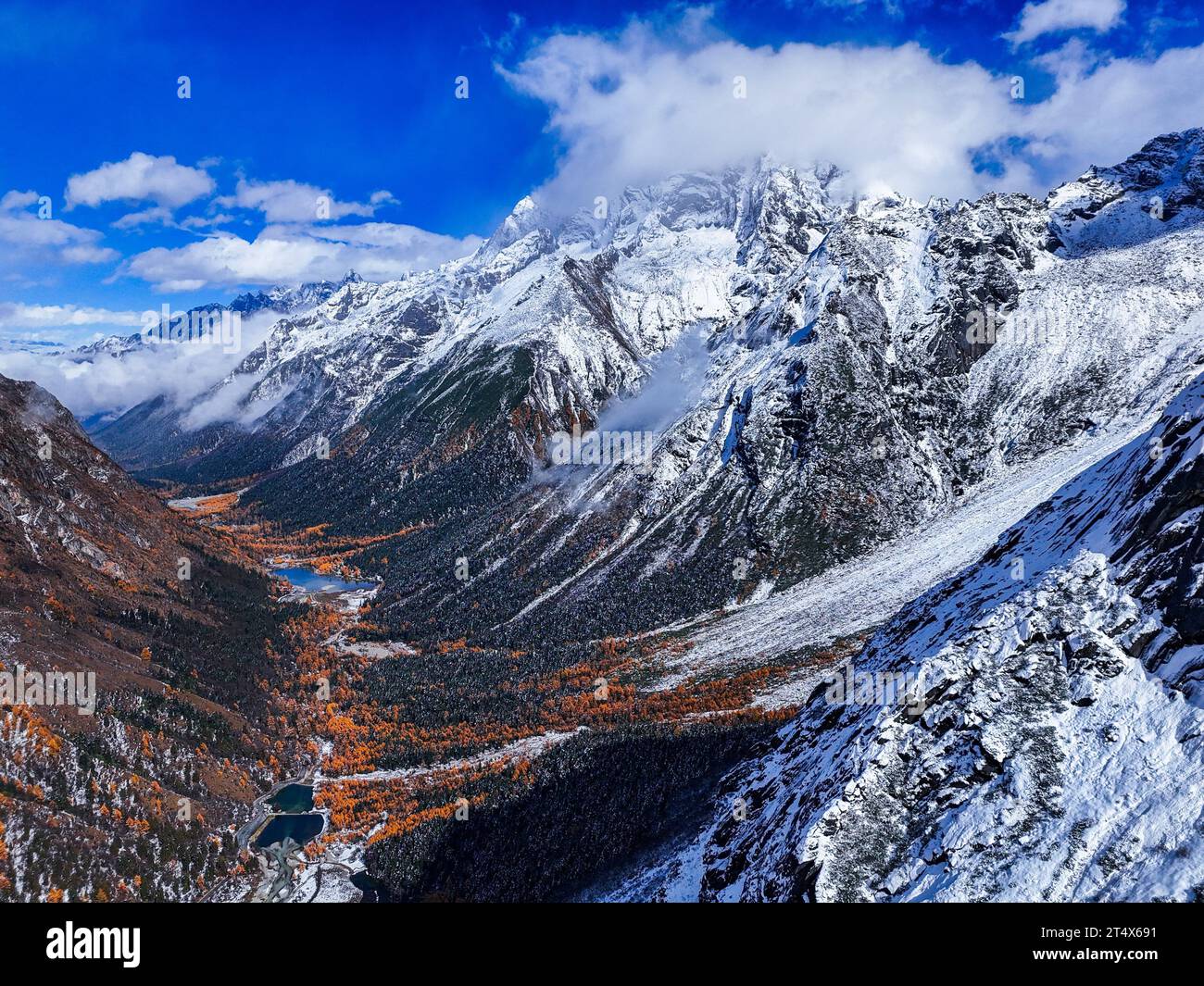 Aerial photo shows the autumn scenery of the snow mountain and colorful ...