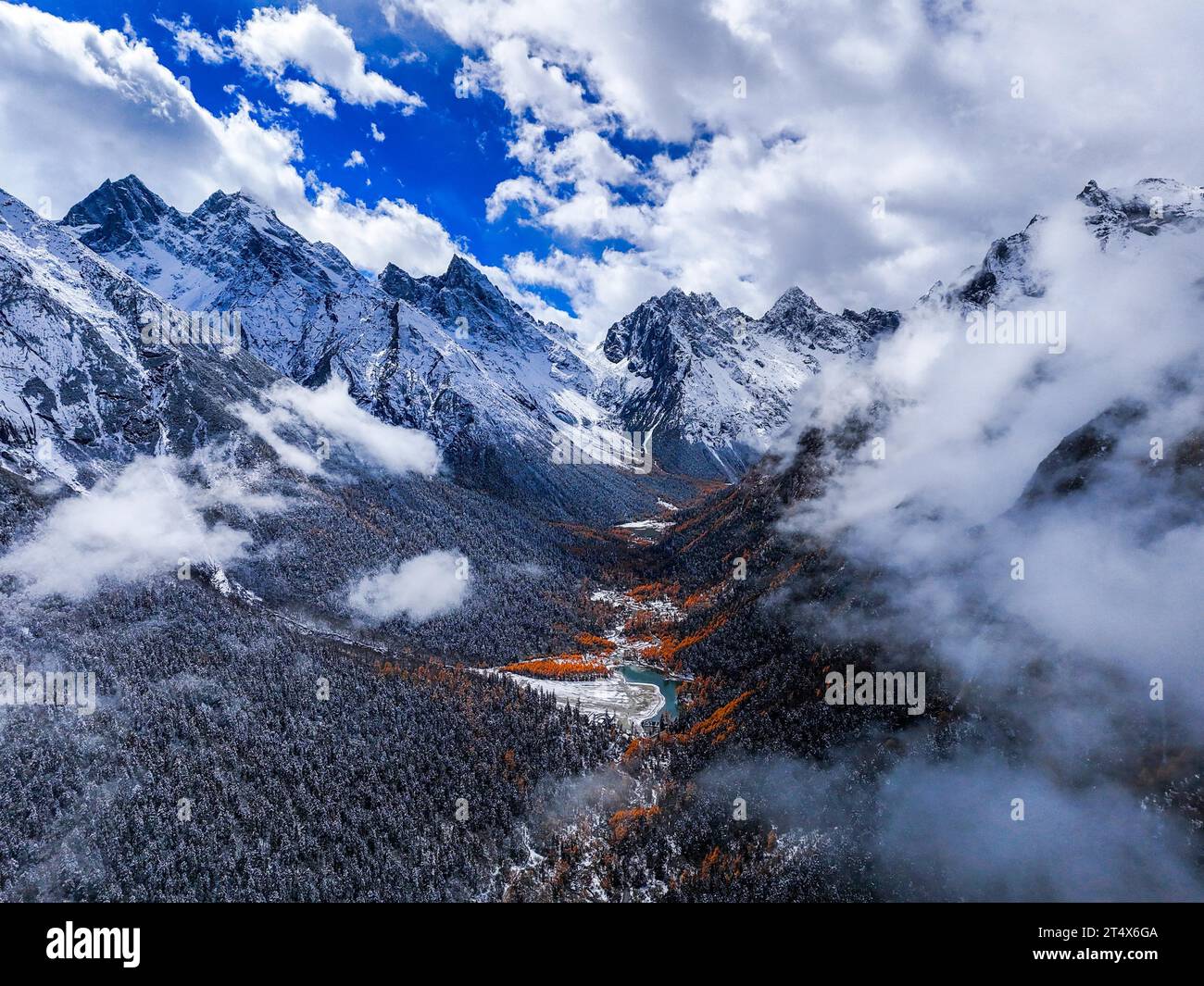 Aerial photo shows the autumn scenery of the snow mountain and colorful ...