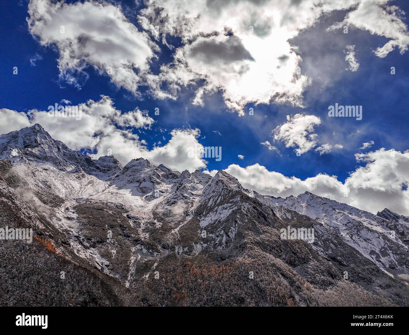 Aerial photo shows the autumn scenery of the snow mountain and colorful ...