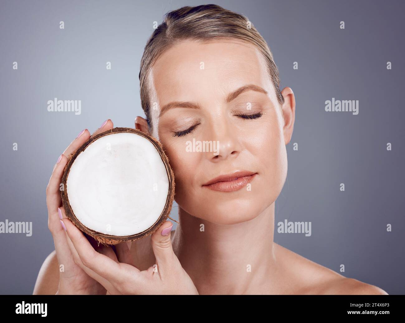 Coconut, woman and skincare for wellness in studio, healthy food and ...