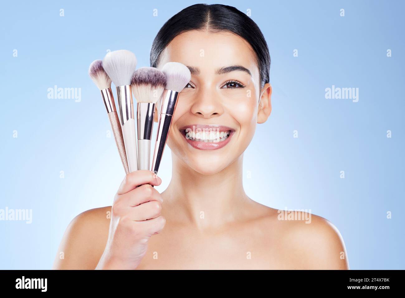 Beauty brushes, makeup and portrait of woman with smile on blue ...