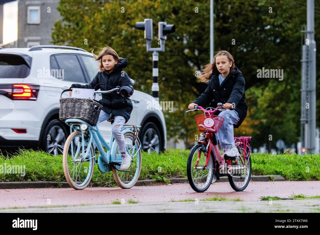 ROTTERDAM - Cyclists brave wind and rain during storm Ciaran. In a ...