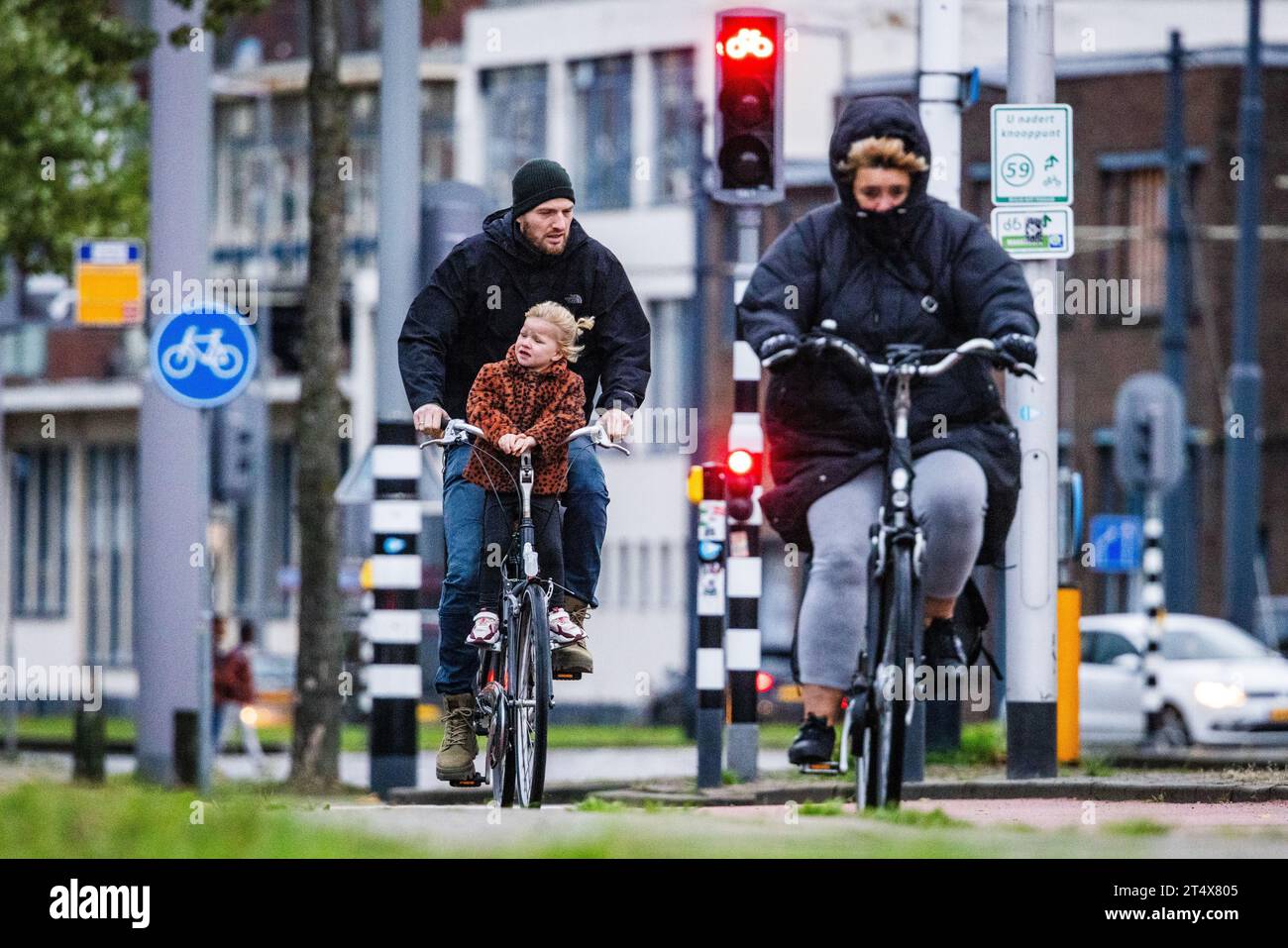 ROTTERDAM - Cyclists brave wind and rain during storm Ciaran. In a ...