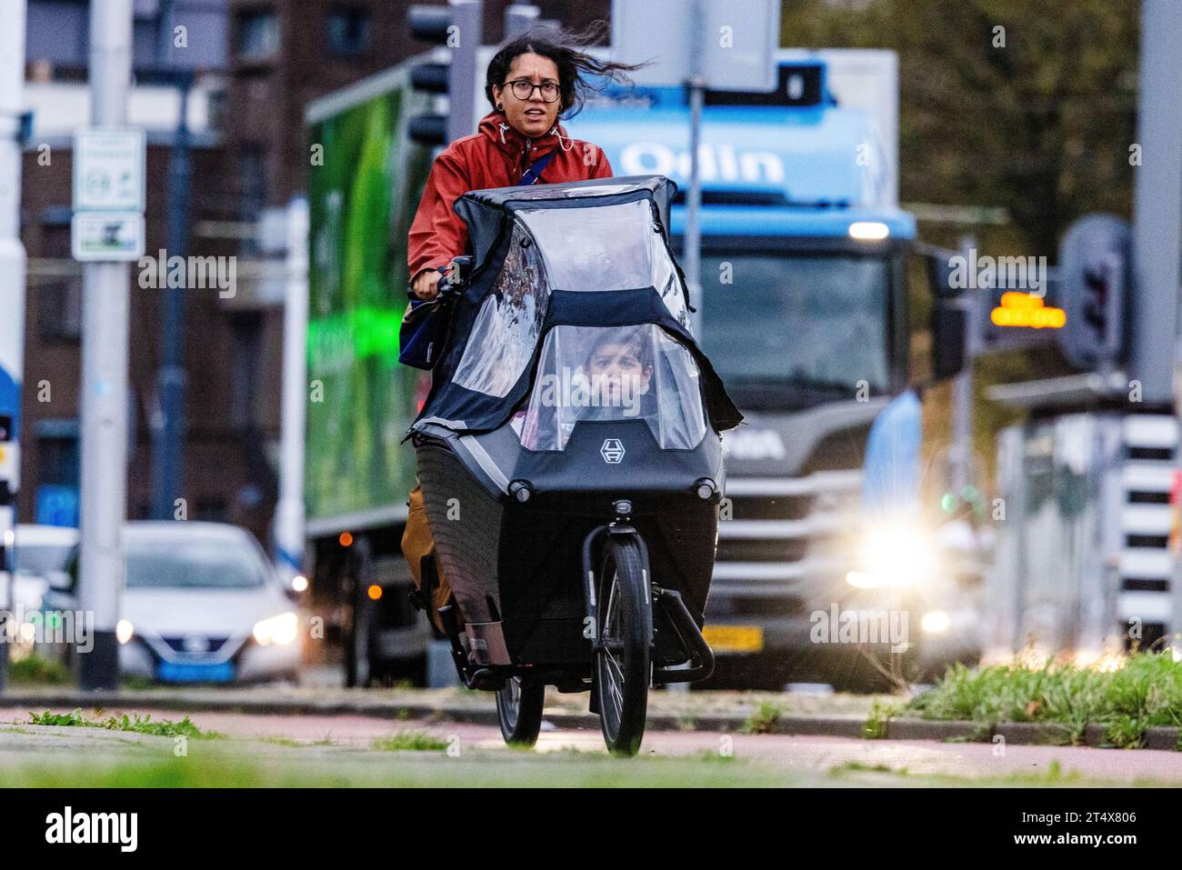 ROTTERDAM - Cyclists brave wind and rain during storm Ciaran. In a ...