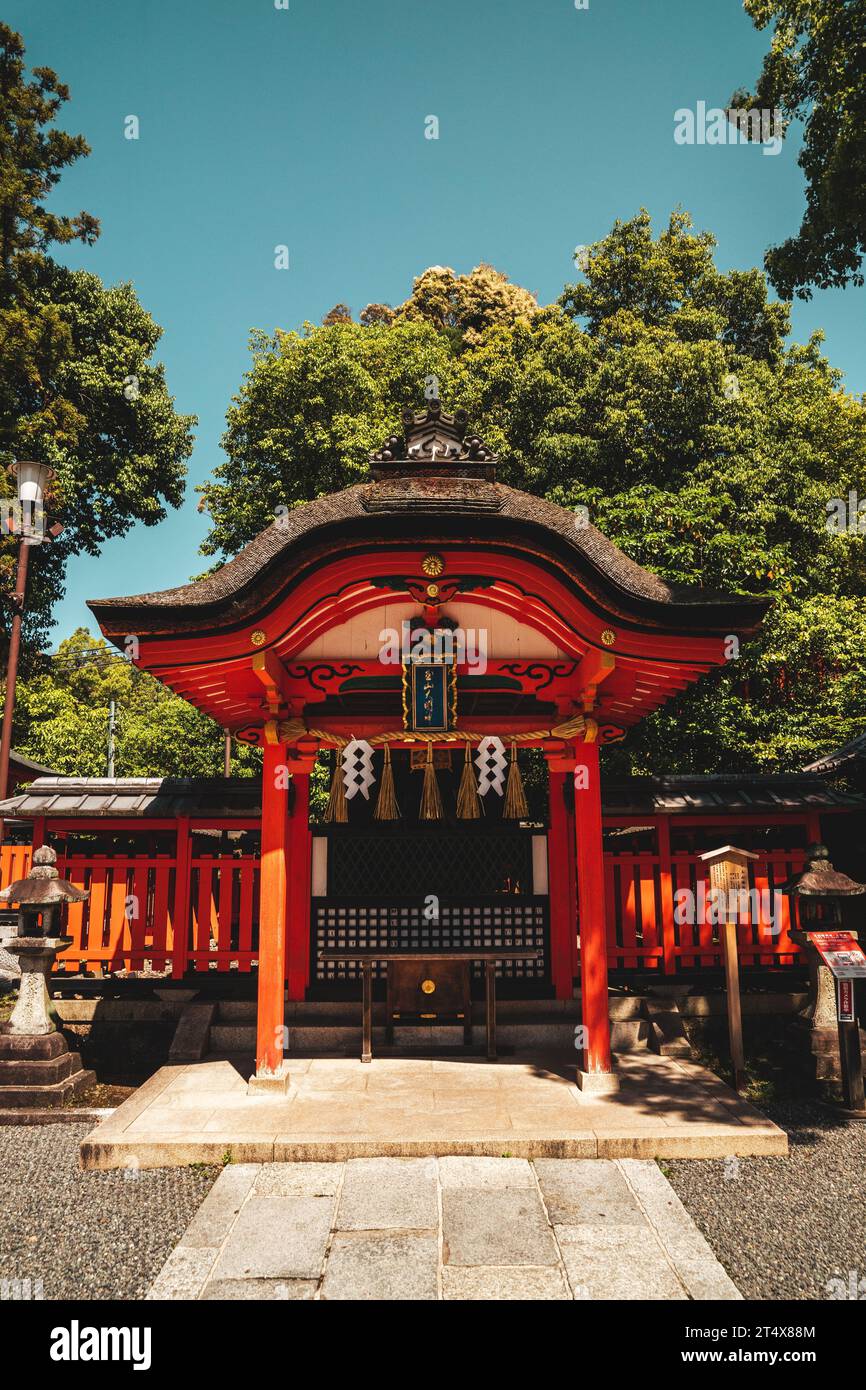 A vibrant and intricate shrine featuring red columns and a multicolored ...