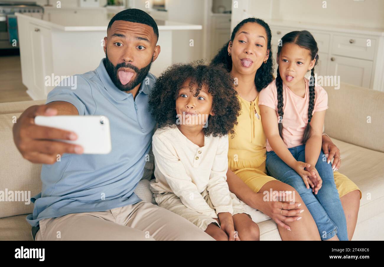 Funny face, family and selfie in home living room, bonding together and ...