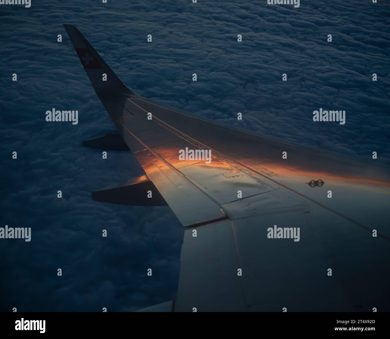 Airplane wing of swiss Airbus a320 at sunset flight from Zurich to ...