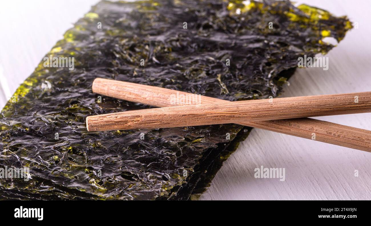 The Nori sheets. Nori sheets with sticks on the wood dish on sunlight ...