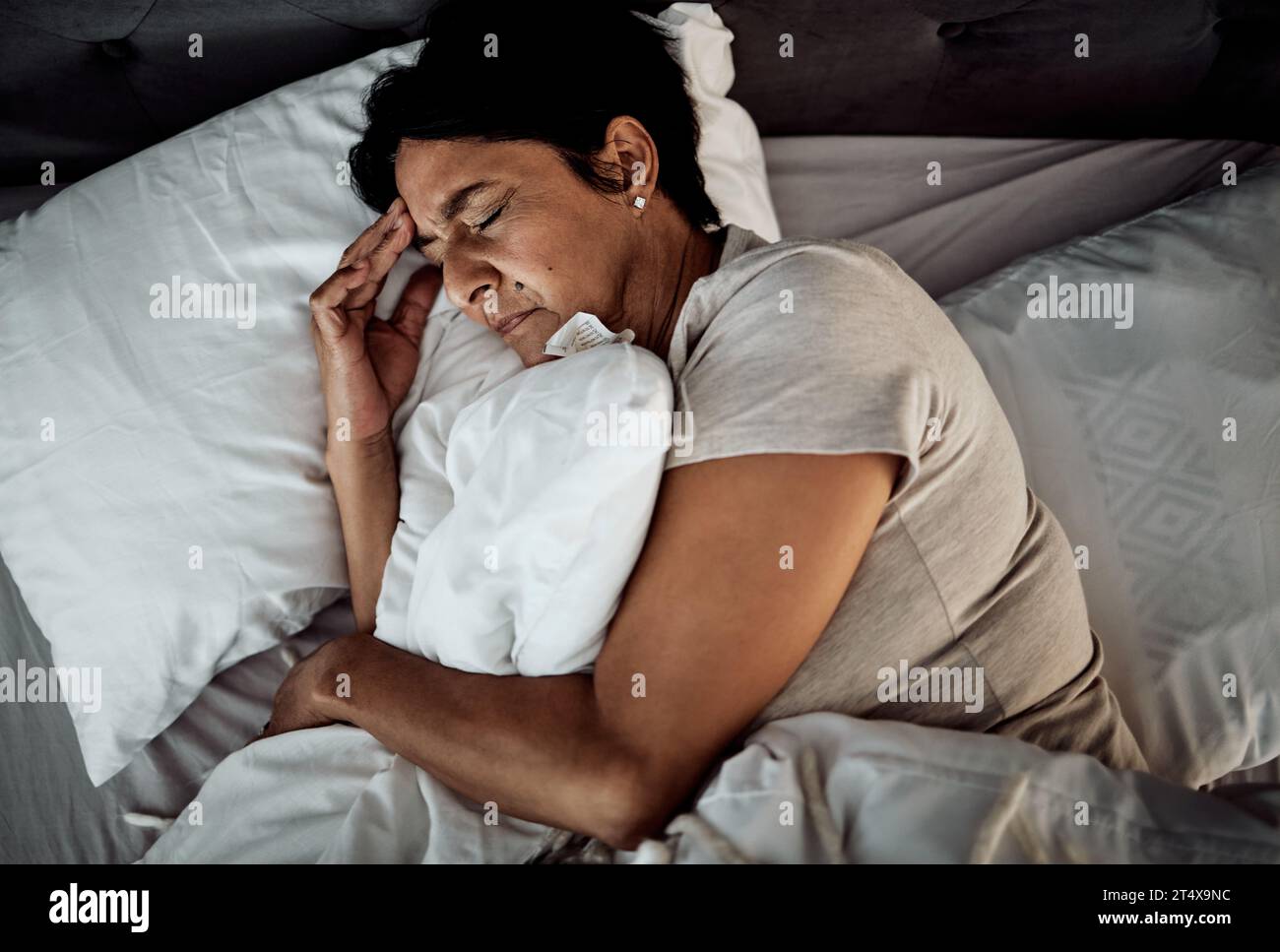 Headache, stress and senior woman in bed from above with depression ...