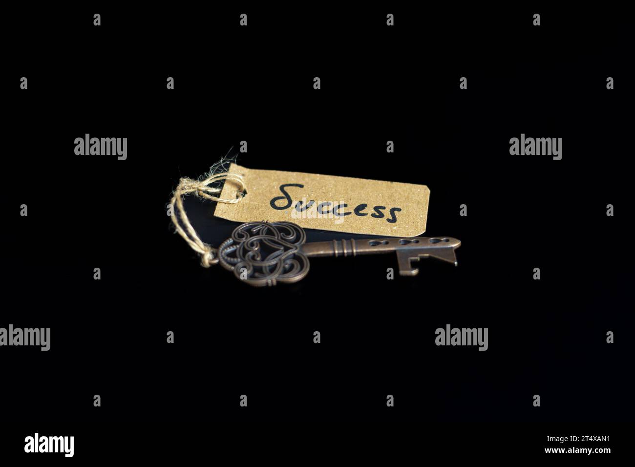 Key to Success concept - Old key with success tag isolated on black ...