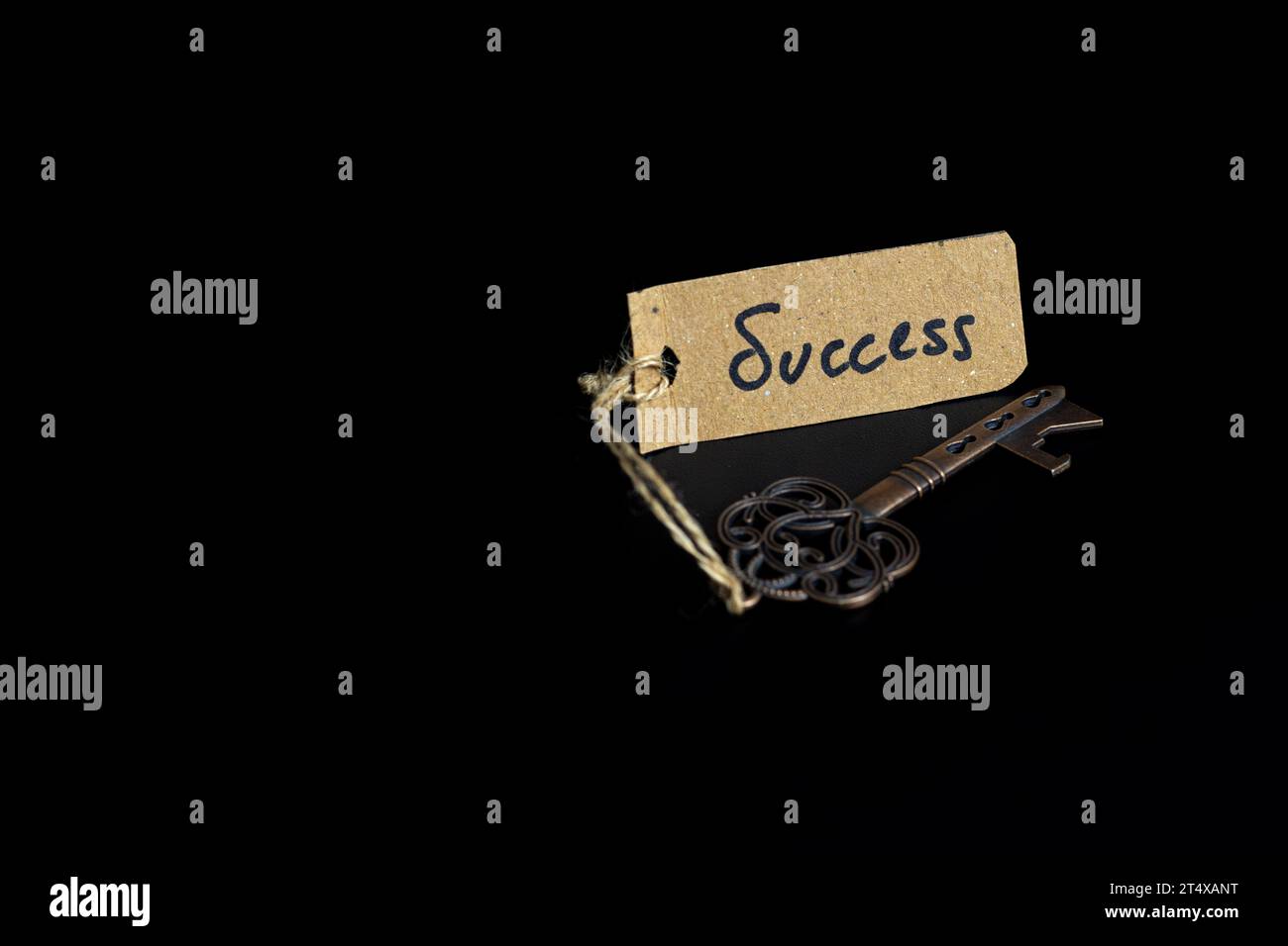 Key to Success concept - Old key with success tag isolated on black ...