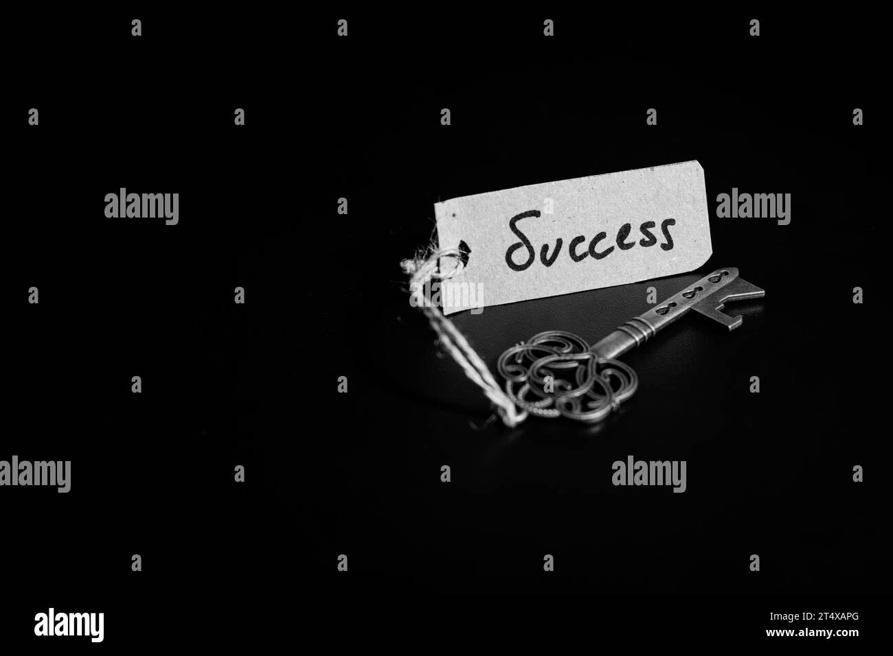 Key to Success concept - Old key with success tag isolated on black ...