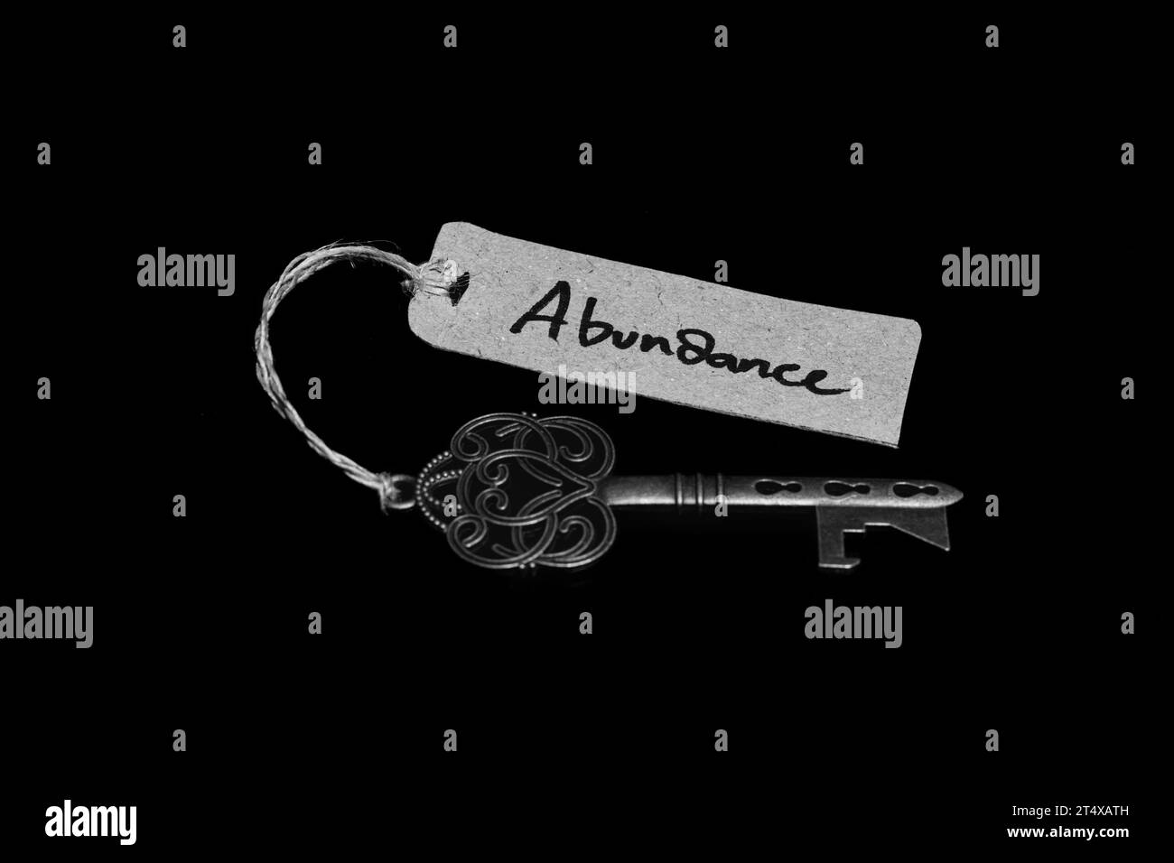 Key to abundant life concept - Old key with abundance tag isolated on ...
