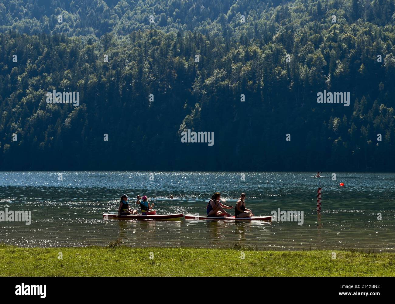 Hiker and cyclists at Weissensee lake recreation area in Füssen ...