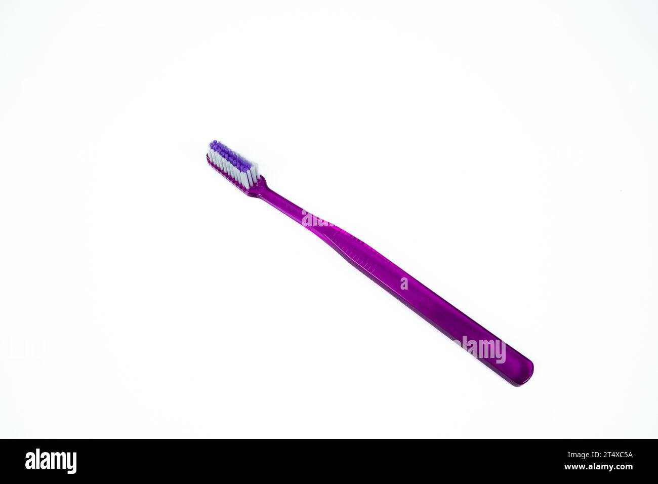 Purple toothbrush on white background Stock Photo - Alamy