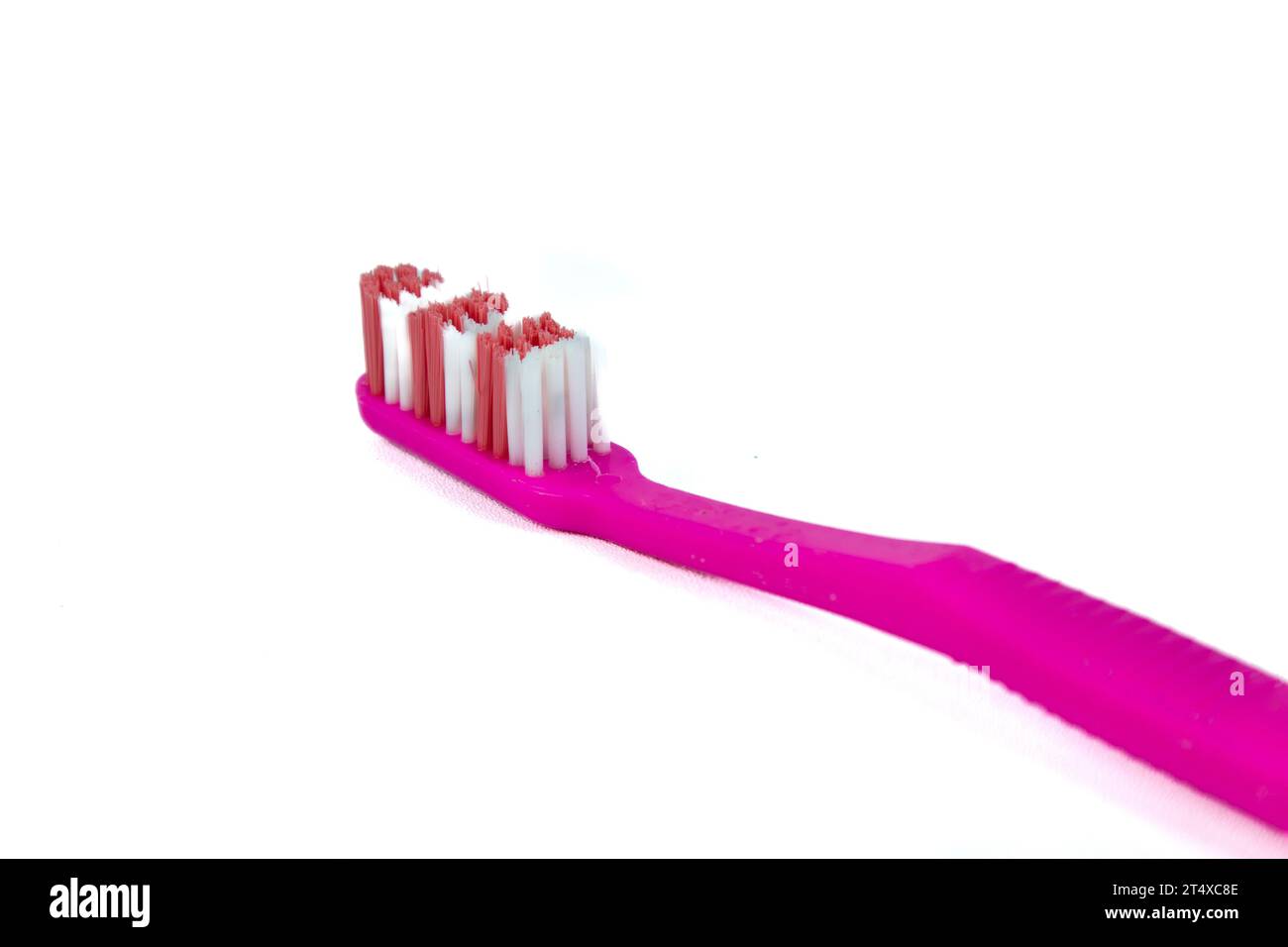 Pink toothbrush on white background Stock Photo - Alamy