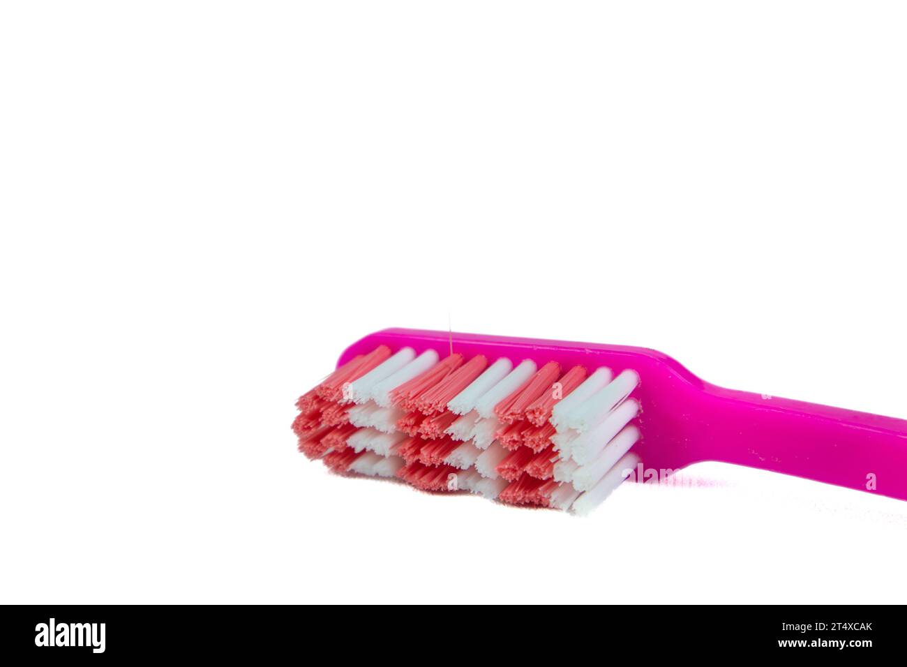Pink toothbrush on white background Stock Photo - Alamy
