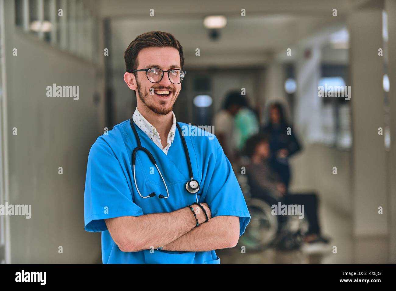 A doctor stands confidently in a hospital hallway with arms crossed ...