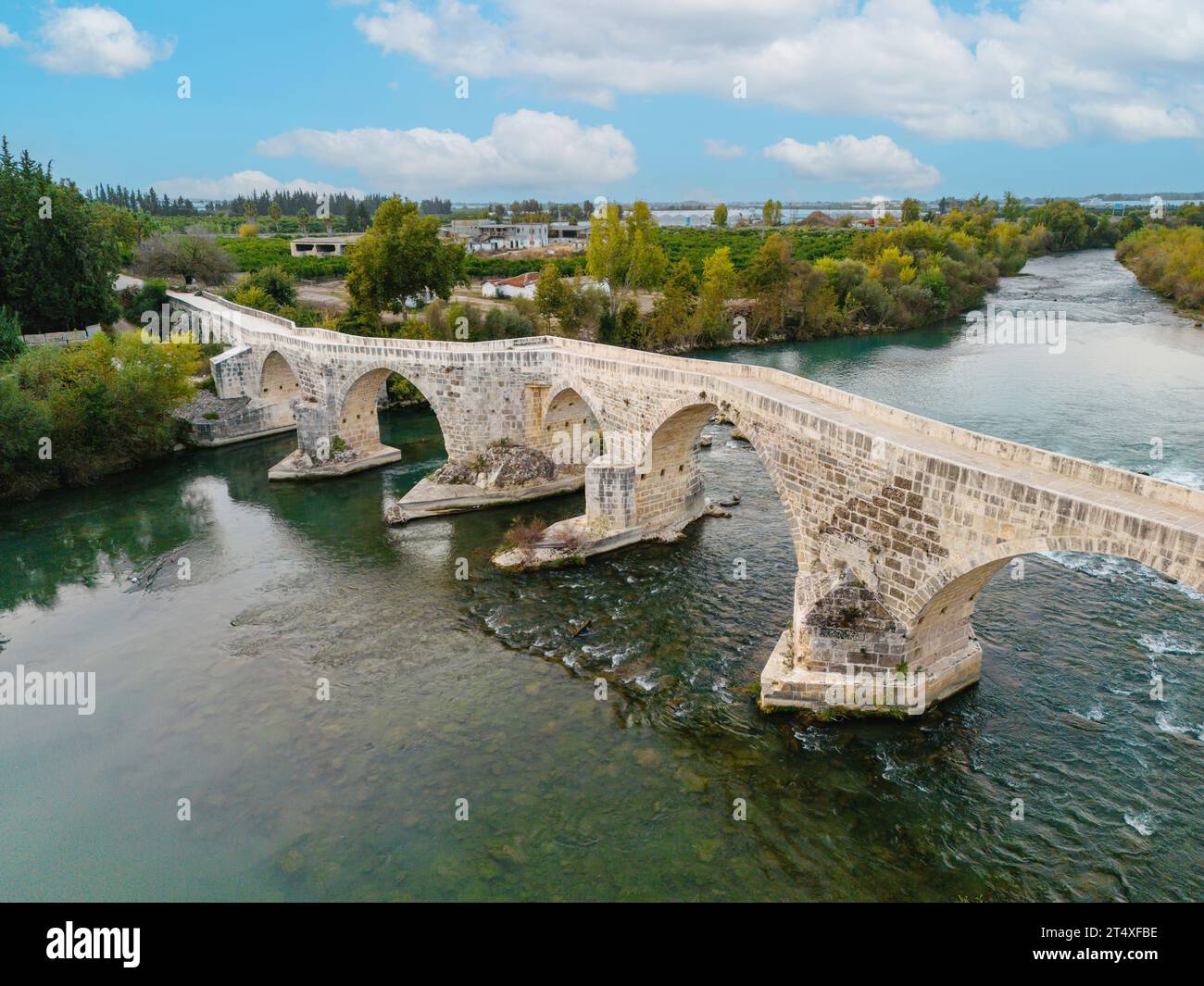 The historical Aspendos Bridge over Koprucay at sunrise in Antalya ...