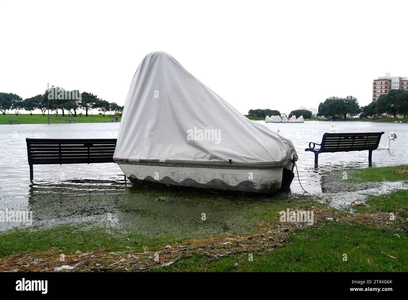 A boat washed up next to submerged benches at Canoe Lake, Southsea ...