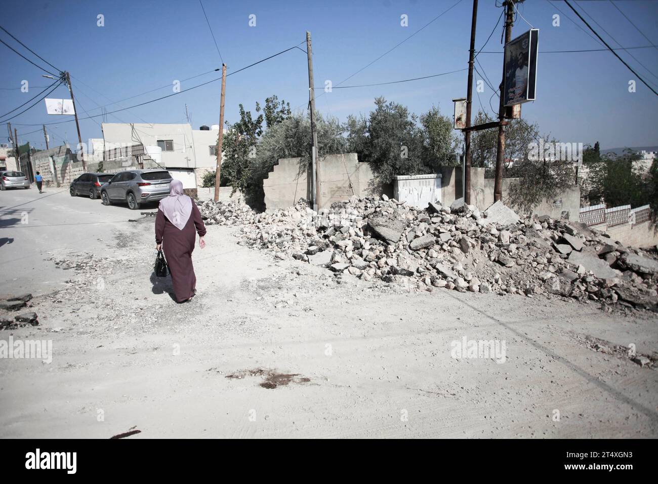 People pass through the destroyed streets on Jenin Refugee Camp after ...