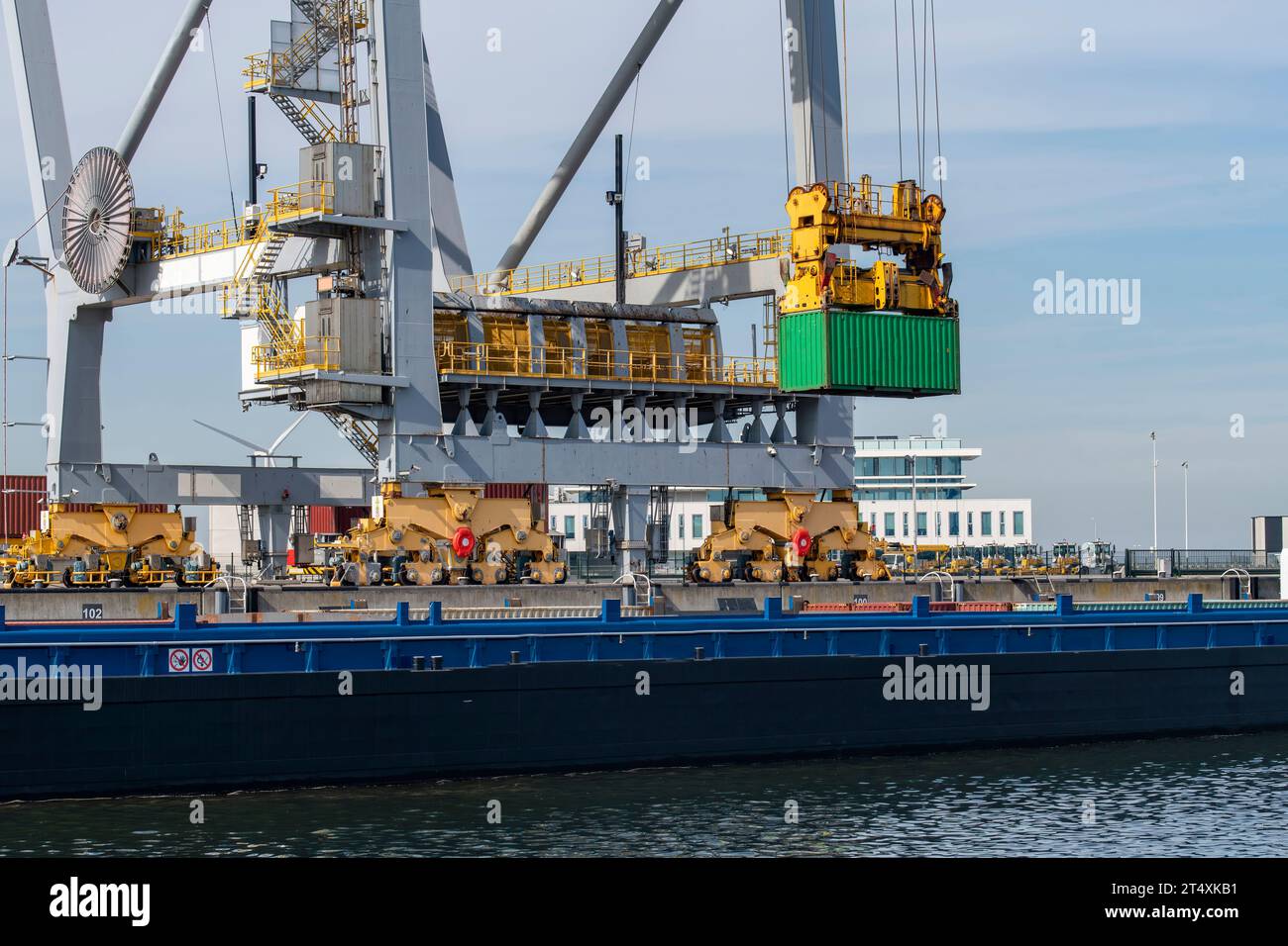 Large gantry cranes moving containers in ‘ship to shore’ logistics into ...