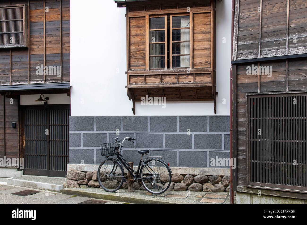 Urban street view of façade of typical Japanese house with modern stone ...