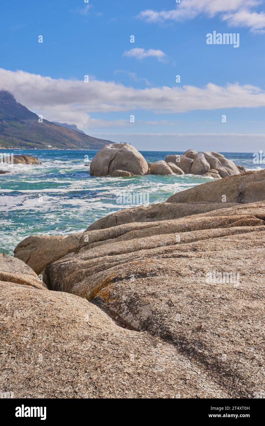 Beautiful sea view of a big boulders and ocean water on a sunny beach ...