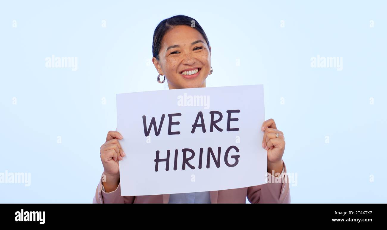 Recruitment, smile and portrait of woman in a studio with a hiring sign ...