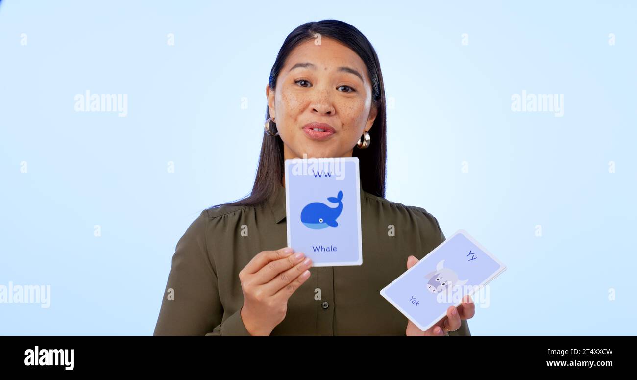 Asian woman, teacher and flash cards for teaching, education and ...