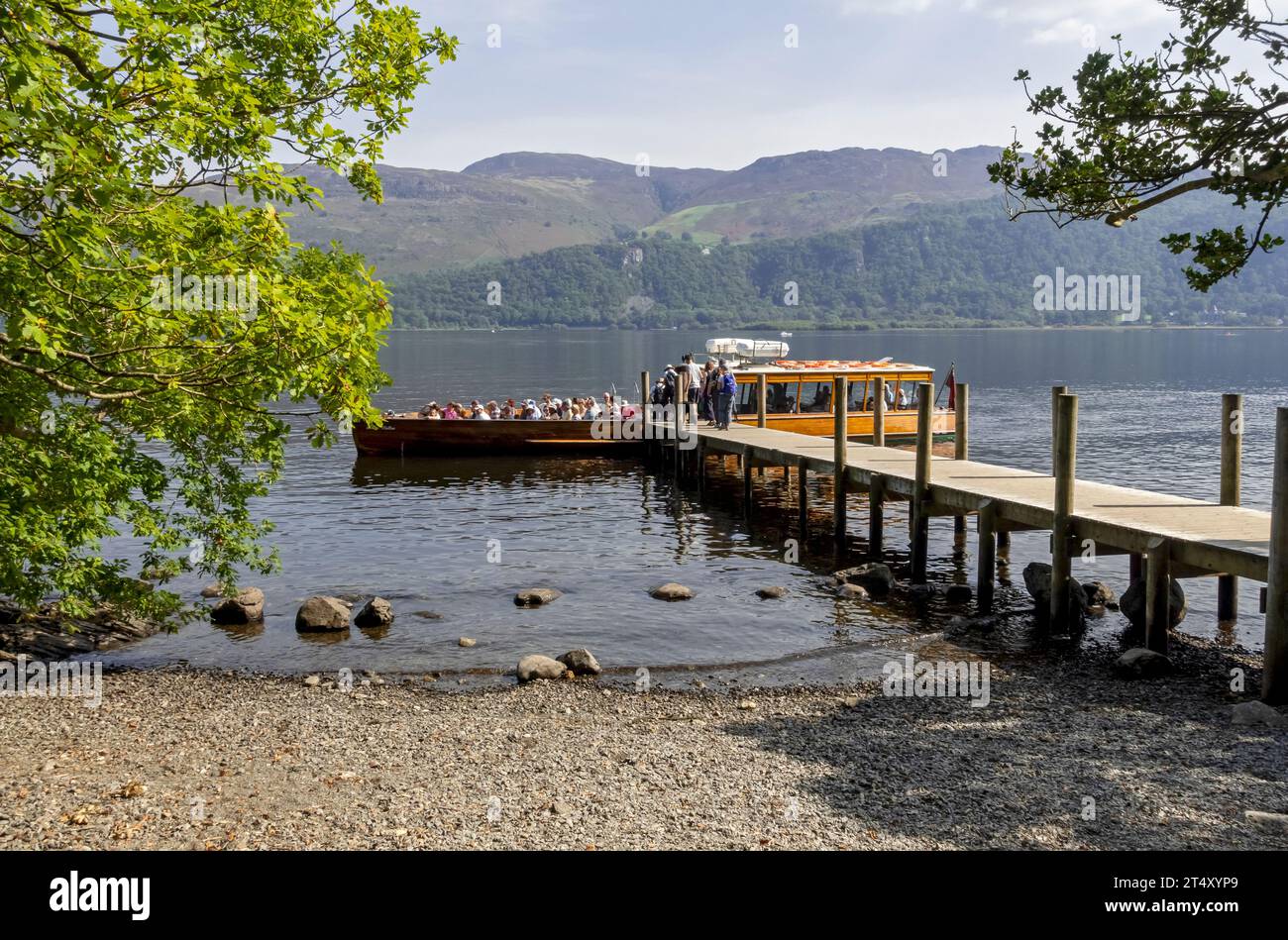 People boarding boat launch at High Brandelhow Bay wooden jetty ...