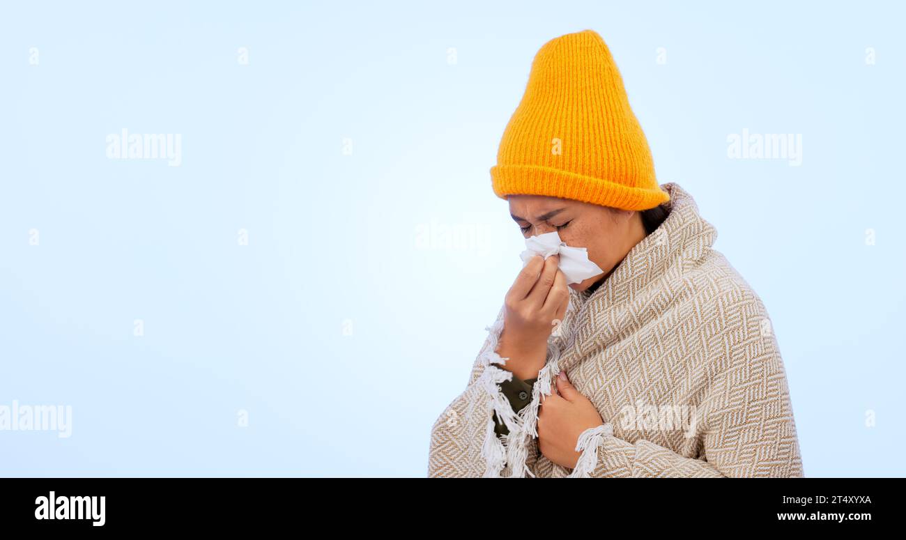 Sinusitis, virus and sick woman with tissue in studio, blue background ...