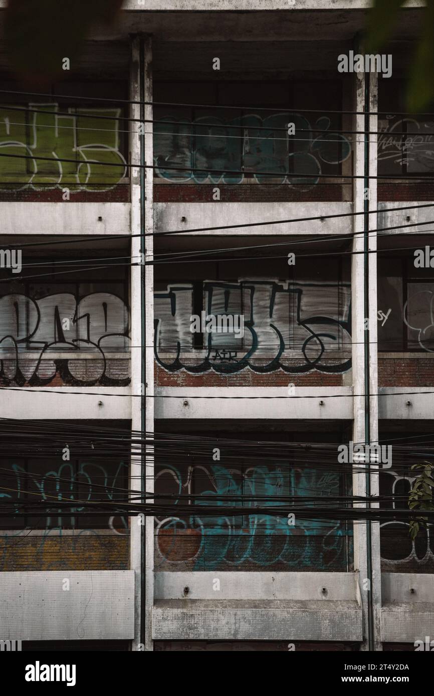 An industrial building in a cityscape featuring a colorful graffiti ...