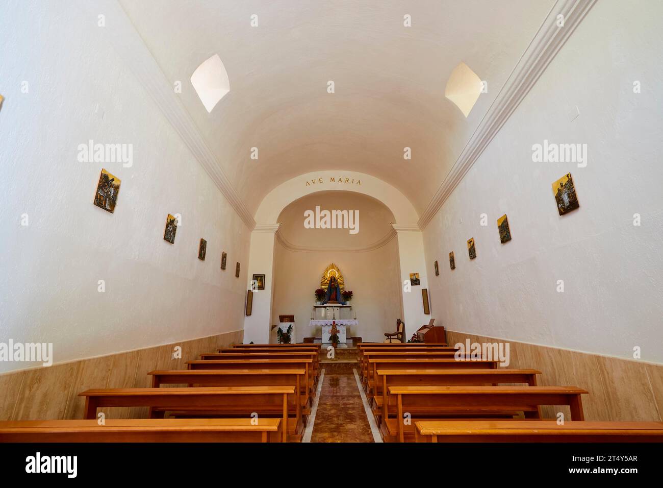Church interior, wide angle, rows of seats, statue of the saint ...