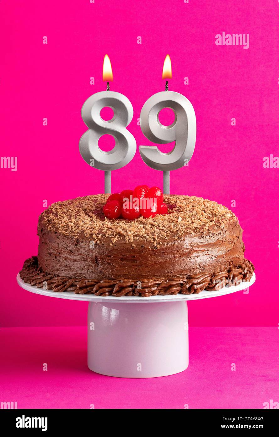 Number 89 candle - Chocolate cake on pink background Stock Photo - Alamy