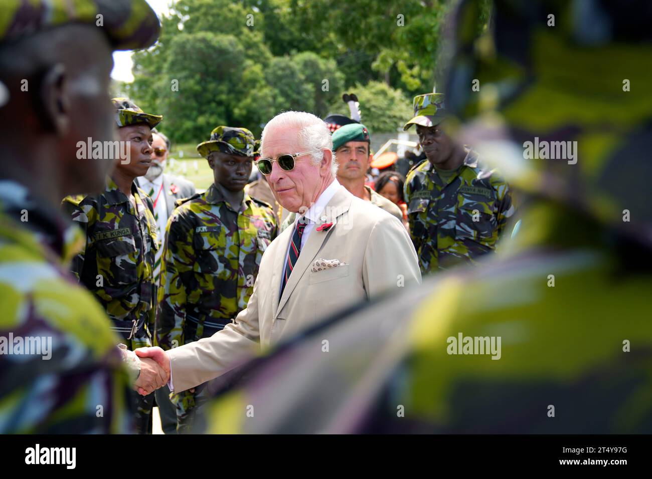 Britain's King Charles III, centre, shakes hands with soldiers during ...