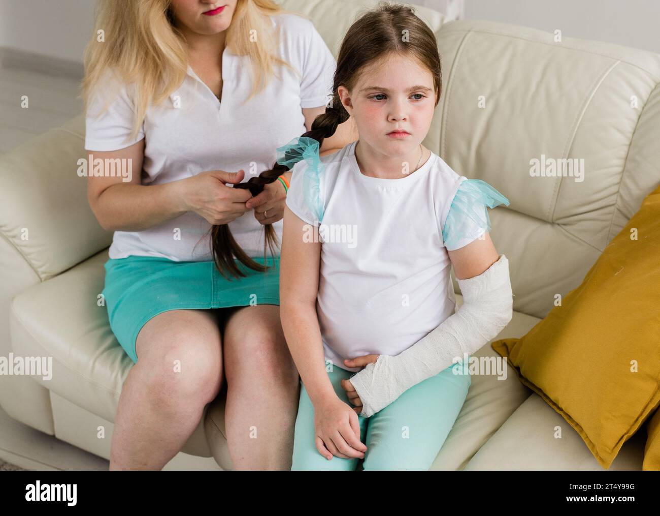 Adorable preschooler girl with a broken arm orthopedic cast at home on ...