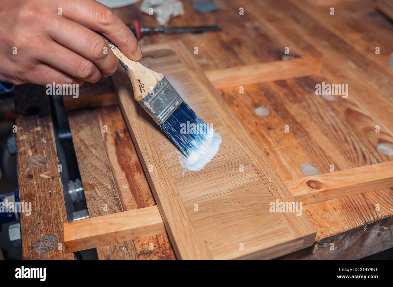 Varnishing a wooden drawer, carpentry workshop. Varnish is applied to a ...