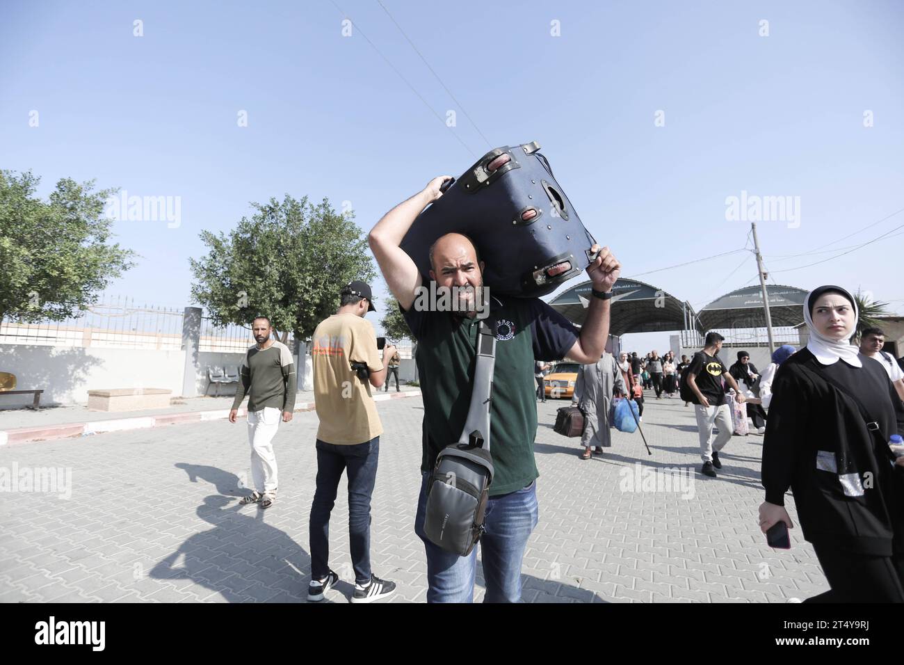 People walk through a gate to enter the Rafah border crossing to Egypt ...