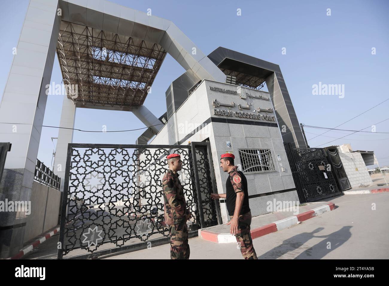 People walk through a gate to enter the Rafah border crossing to Egypt ...