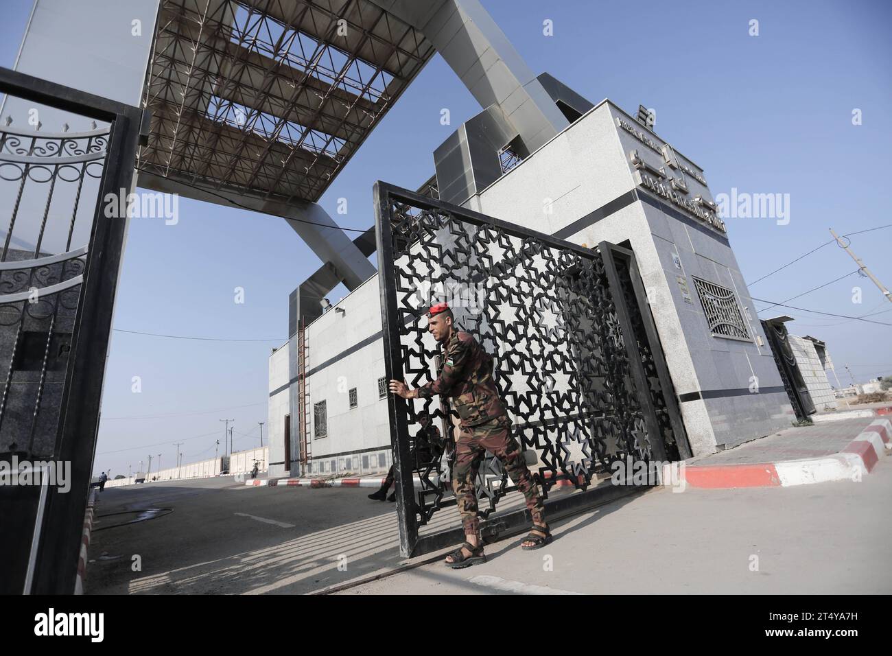 People walk through a gate to enter the Rafah border crossing to Egypt ...